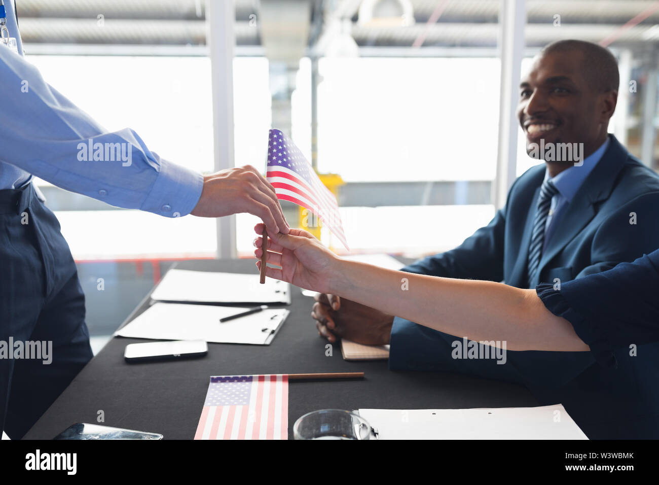 Business people holding an American flag at conference registration ...