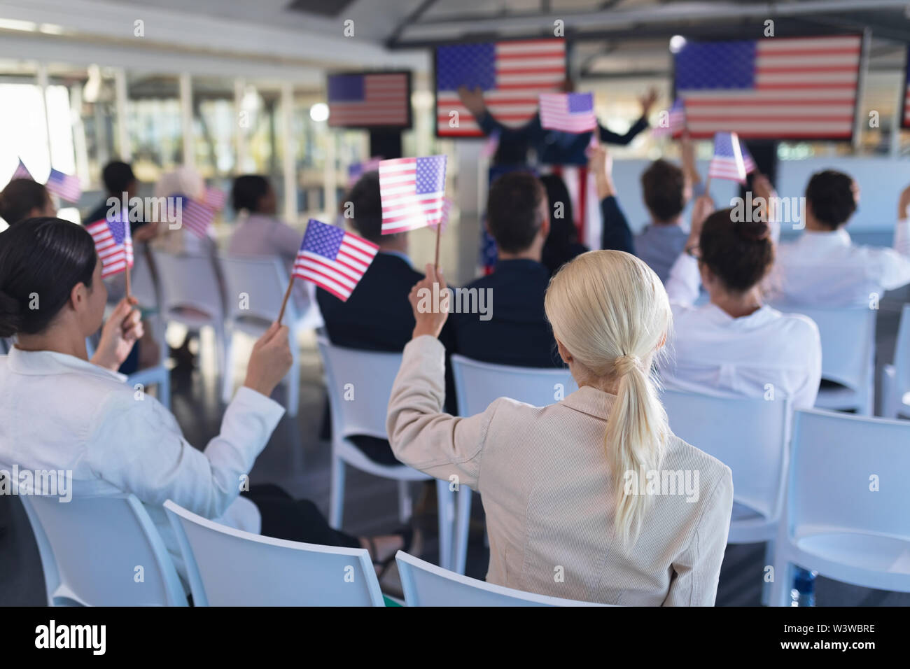 Business people waving an American flag in business seminar Stock Photo ...
