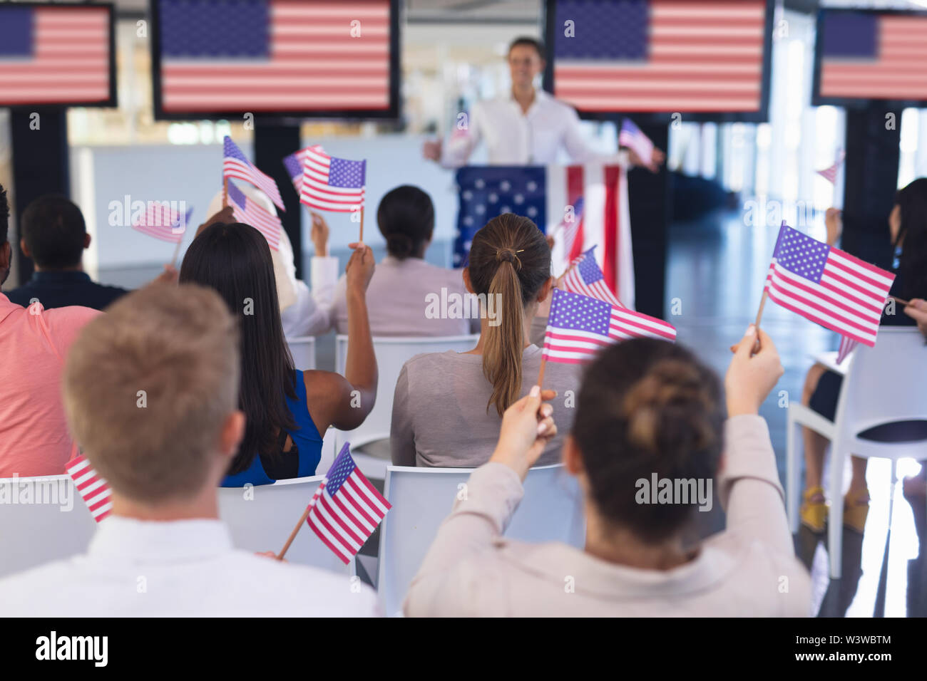 Business people waving an American flag in business seminar Stock Photo ...
