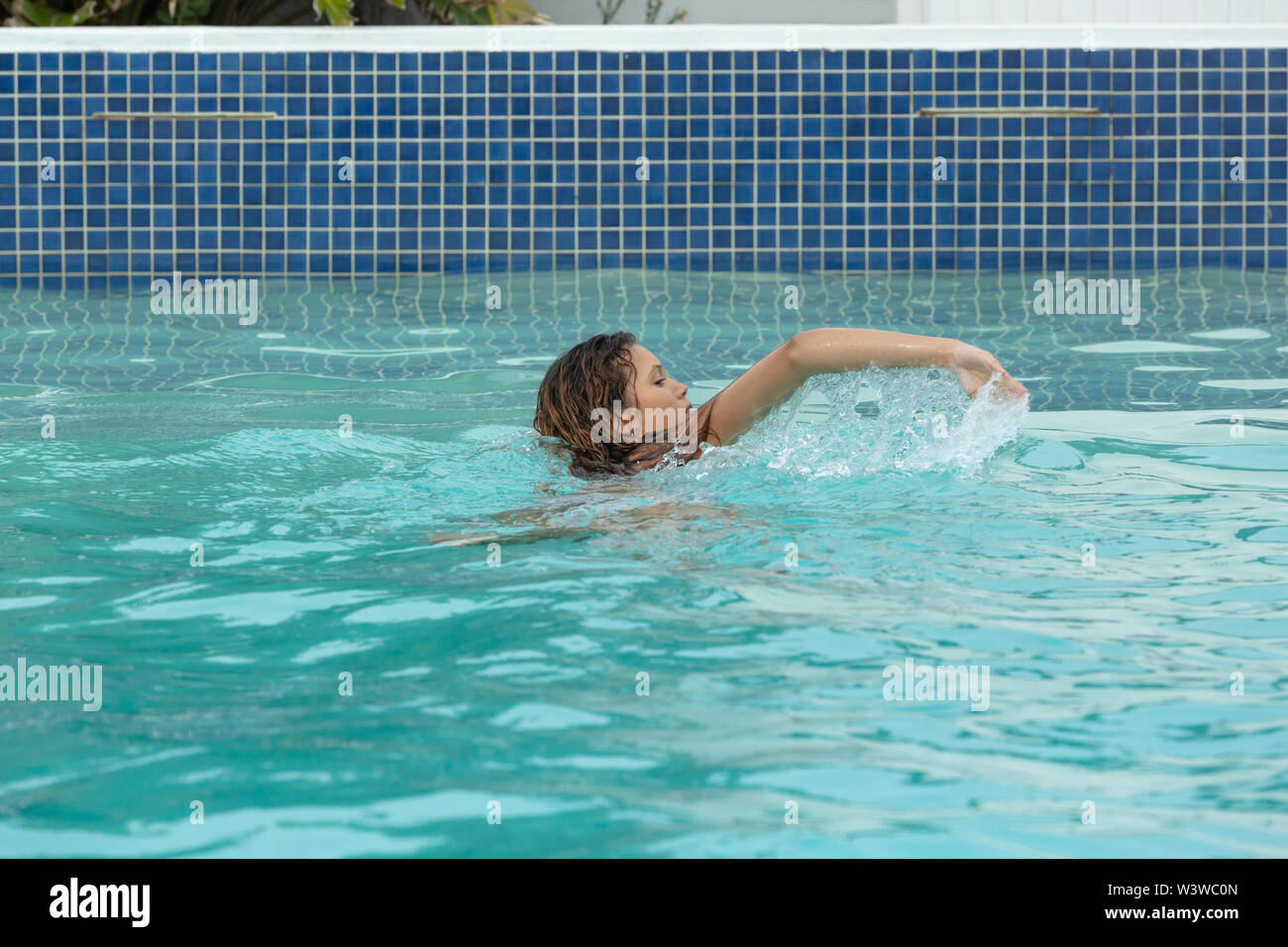 Woman swimming in swimming pool in the backyard at home Stock Photo - Alamy