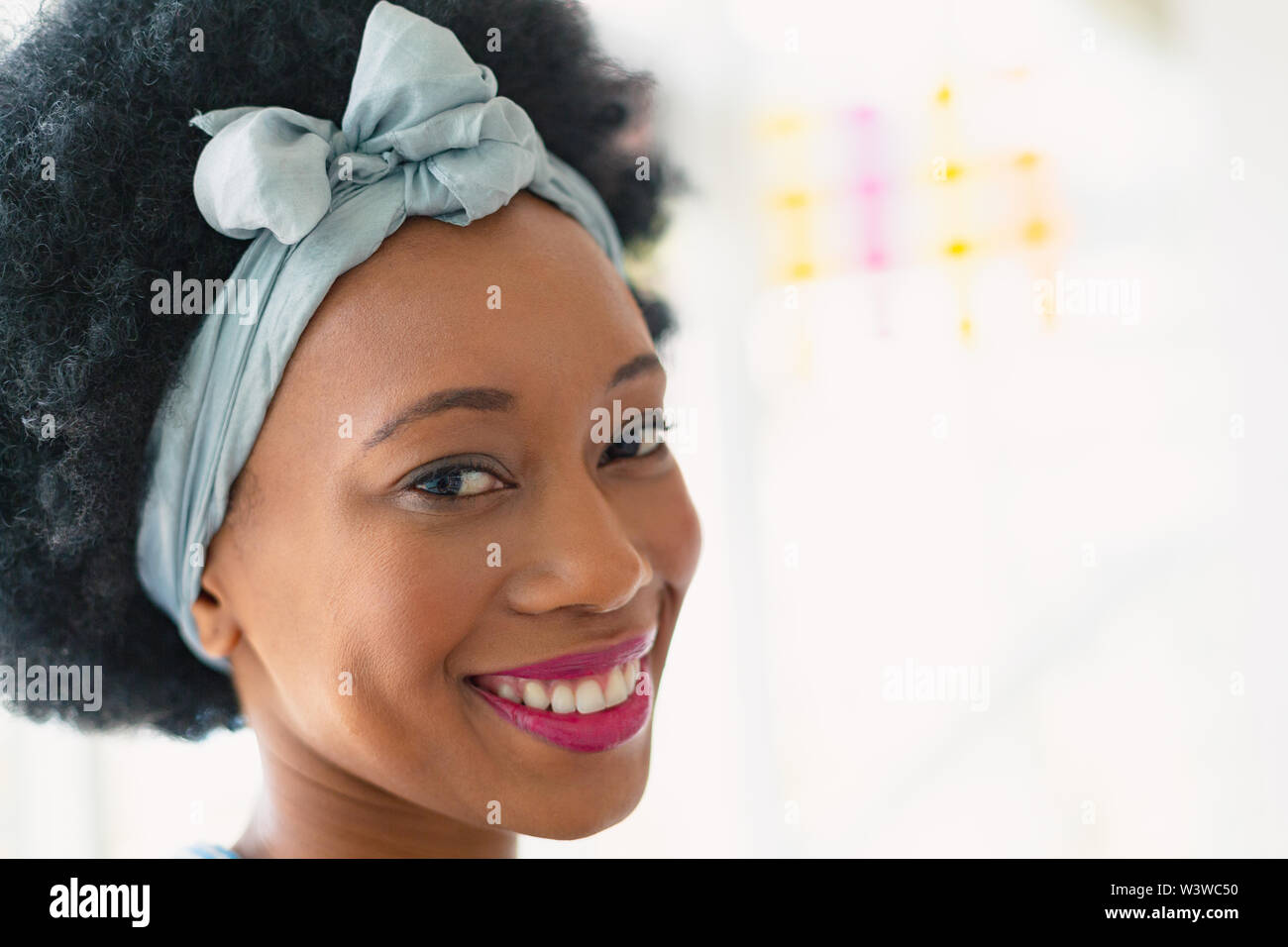 Female graphic designer smiling in office Stock Photo - Alamy