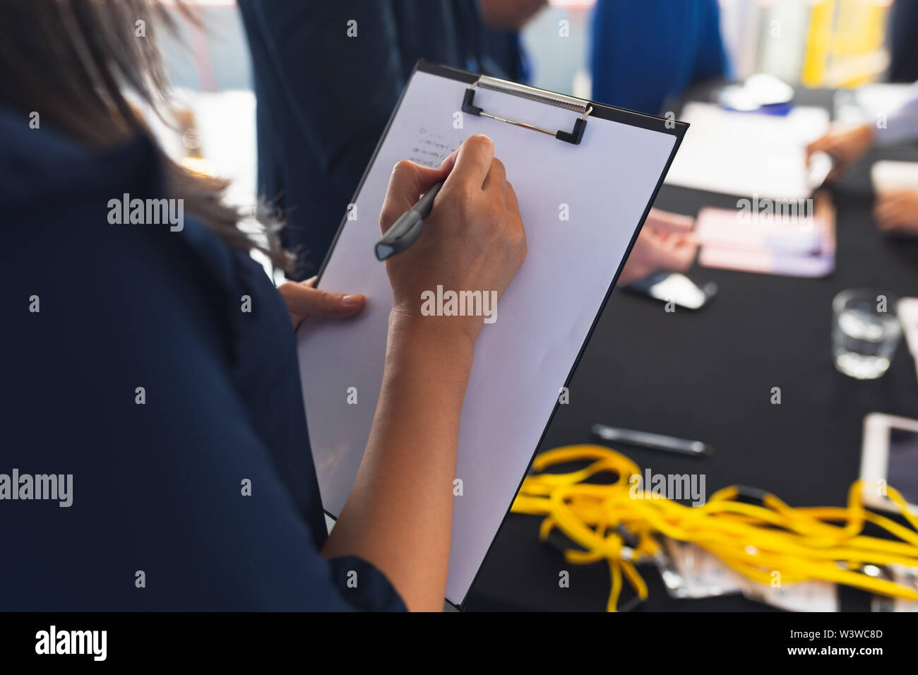 Businesswoman checking in at conference registration table Stock Photo ...
