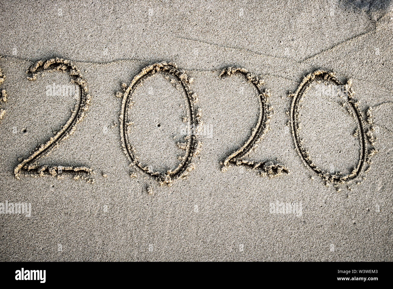 This unique photo shows the 2020 year written in the sand. This picture ...