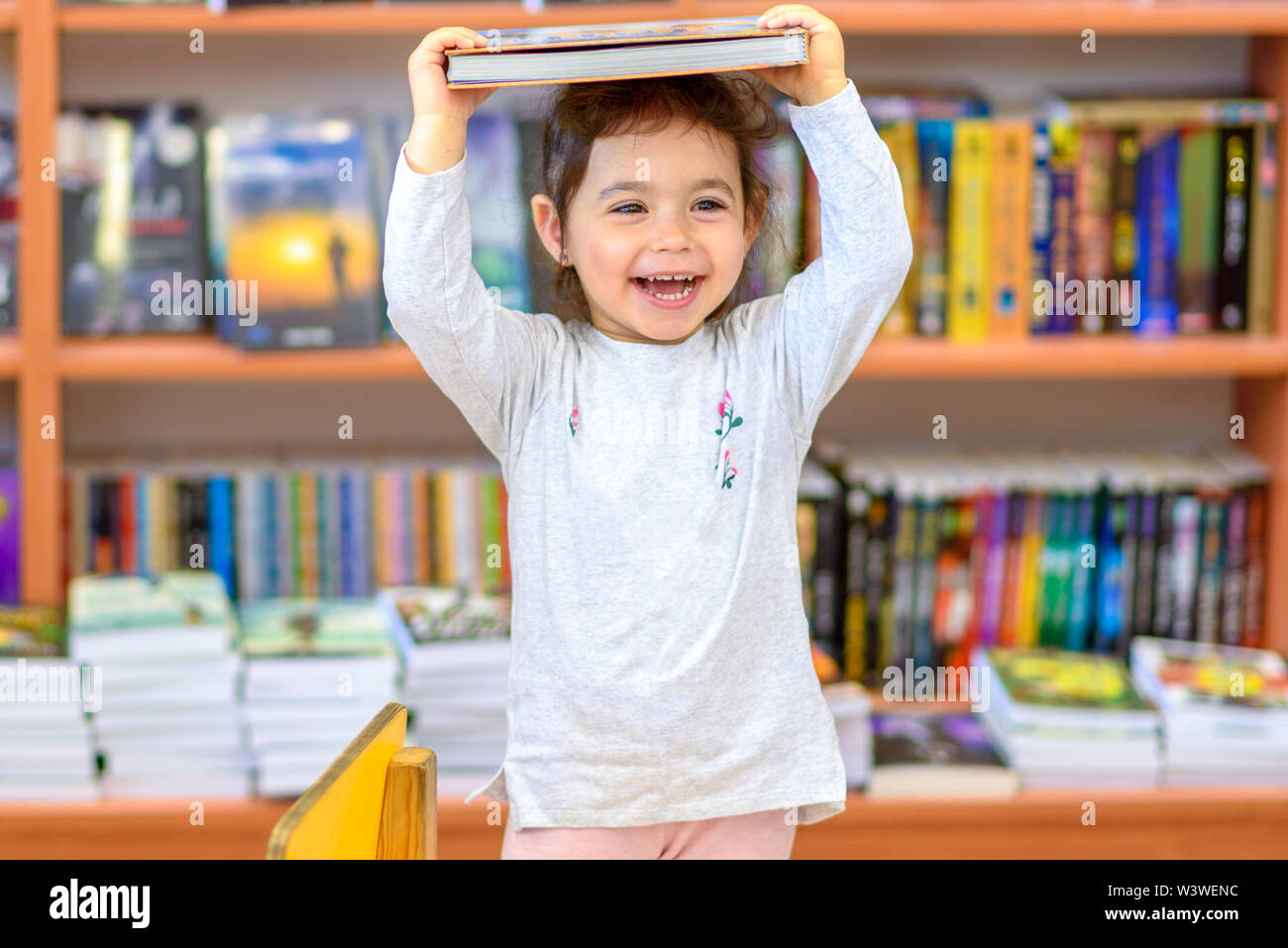Cute Young Toddler Standing and Holding Book in Head. Little Happy ...