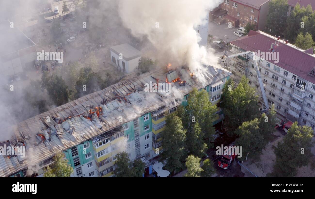 Burning roof of a residential high-rise building, clouds of smoke from ...
