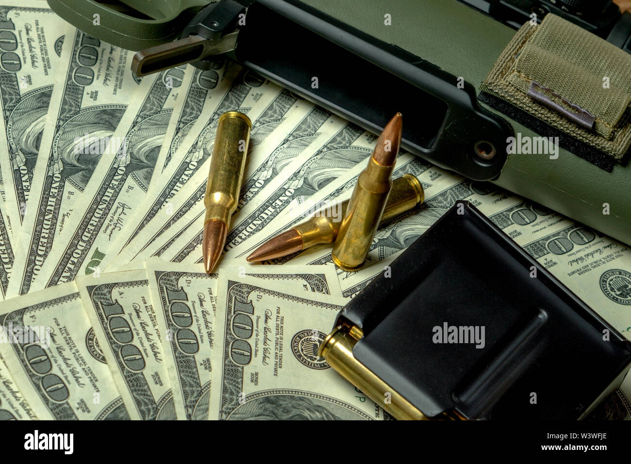 Rifle, magazine and cartridges on hundred dollar bills. Concept for ...