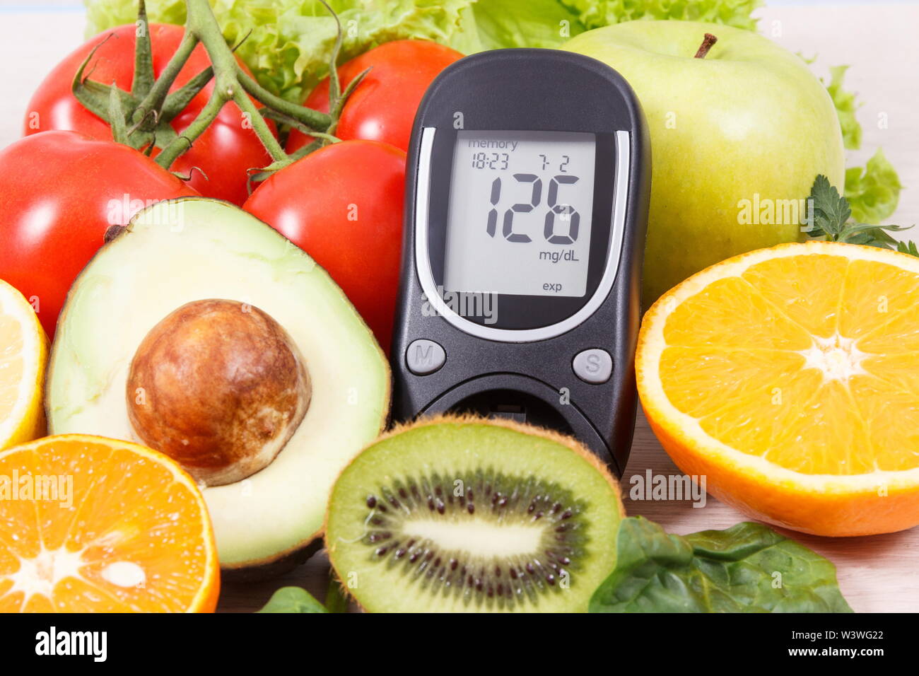 Glucometer with result of sugar level and healthy fruits and vegetables ...