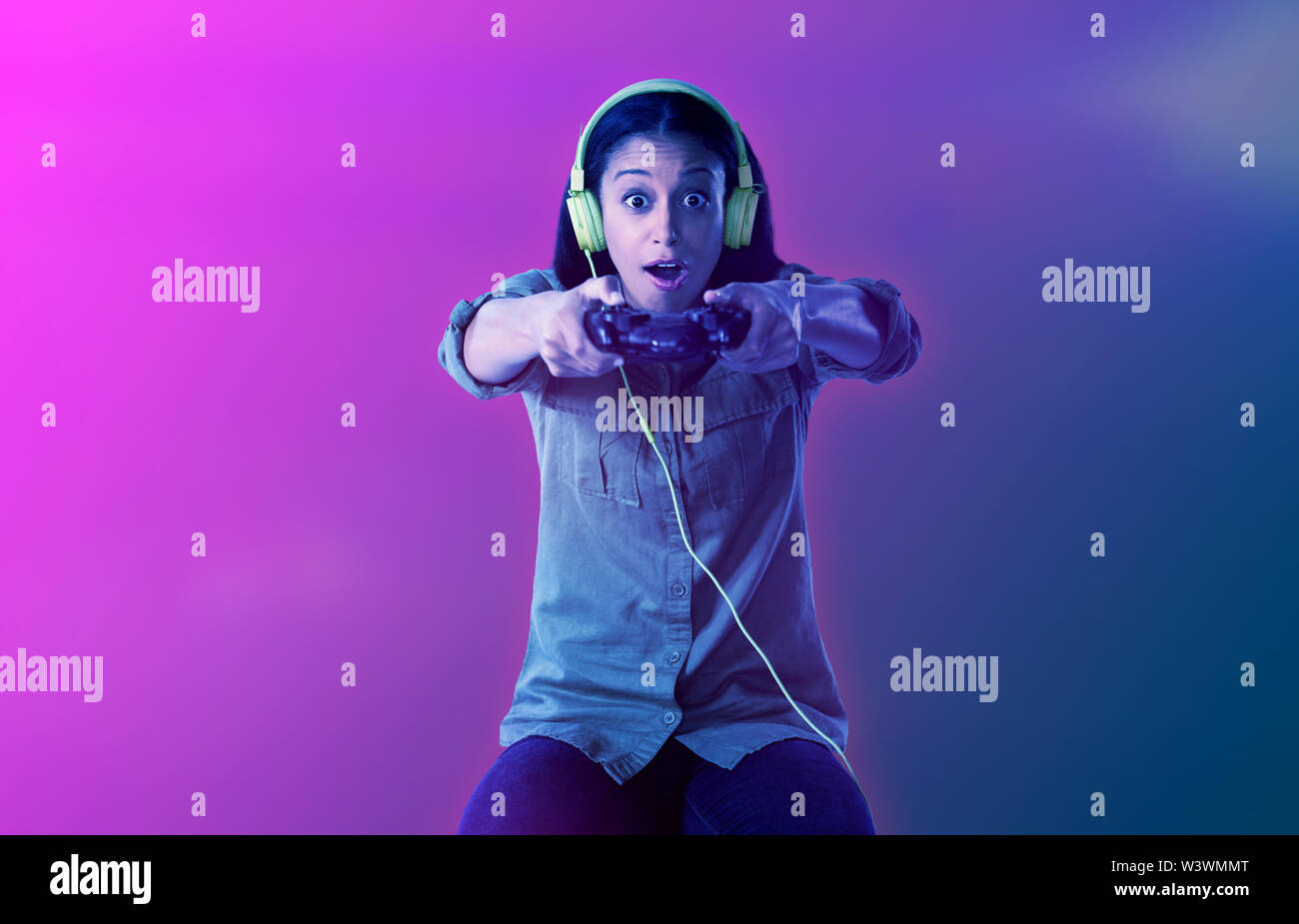 Composite image of woman making funny faces while playing video games ...