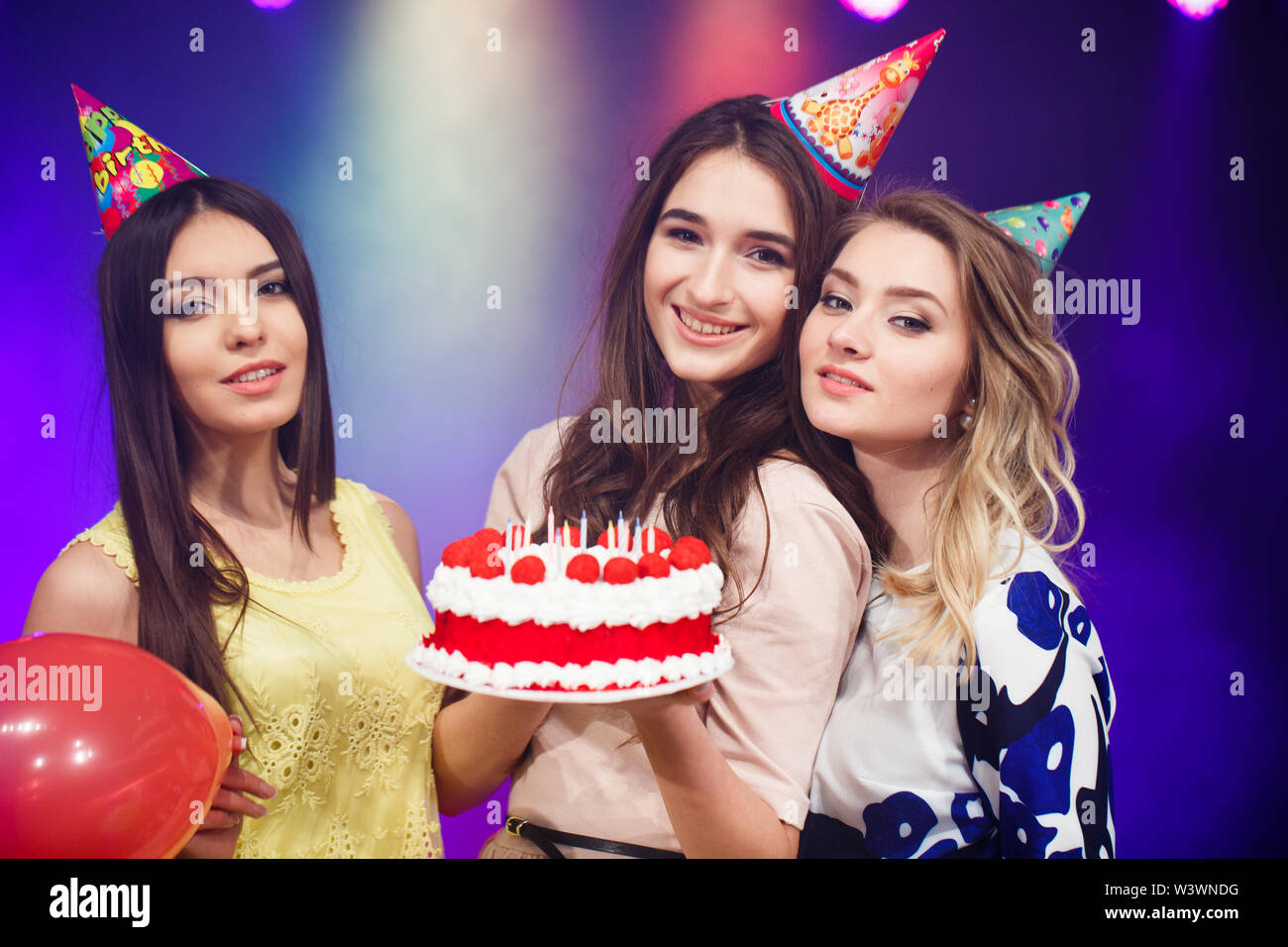 Happy birthday. Group of smiling friends gathered together with cake ...