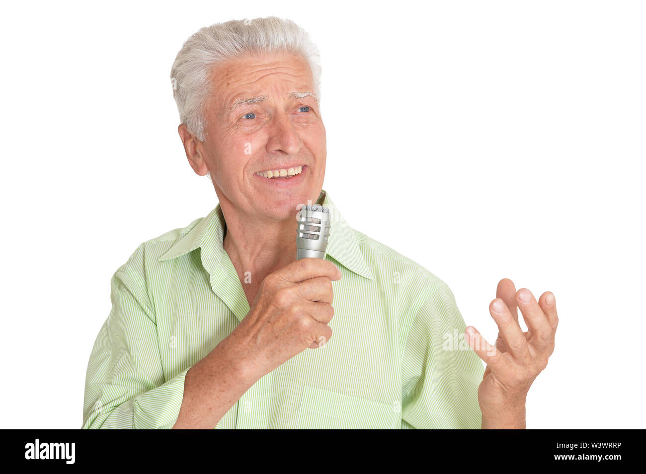Senior man singing with microphone on white background Stock Photo - Alamy