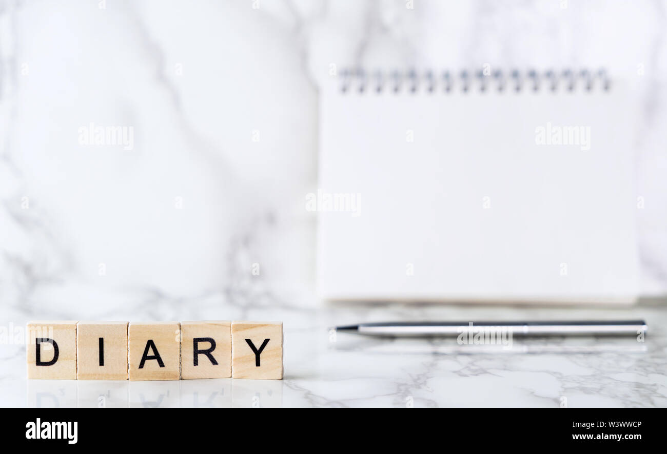 Diary text with blank notebook in backgorund Stock Photo - Alamy