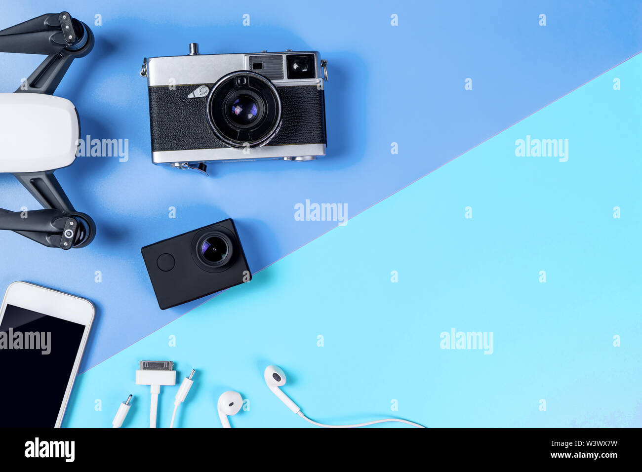 Hi tech travel gadget and accessories on blue copy space with drone ...