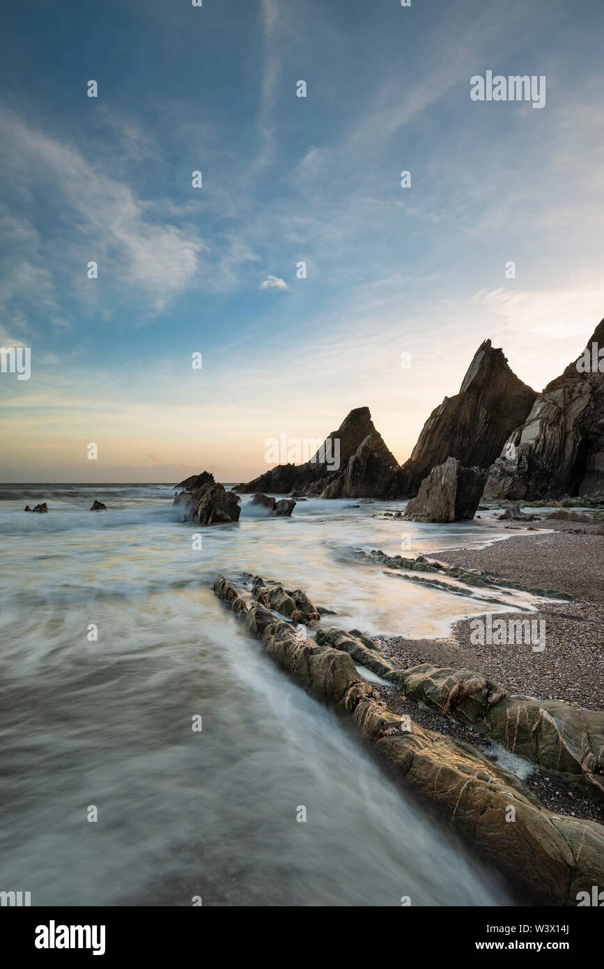 Beautiful sunset landscape image of Westcombe Beach in Devon England ...