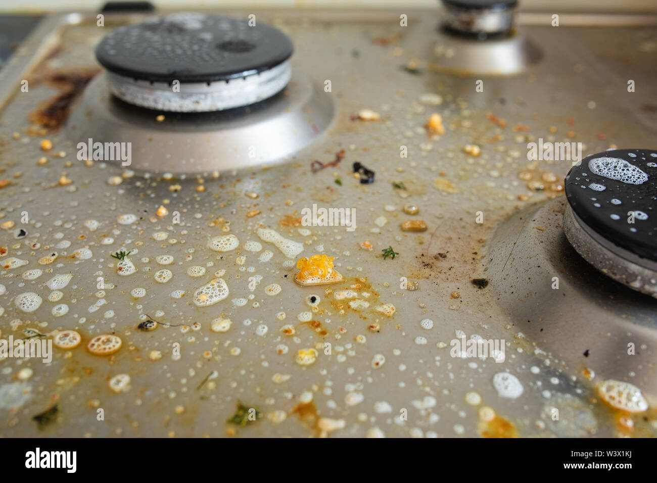 Washing process of gas cooker.Close-up of dirty gas cooker covered with ...