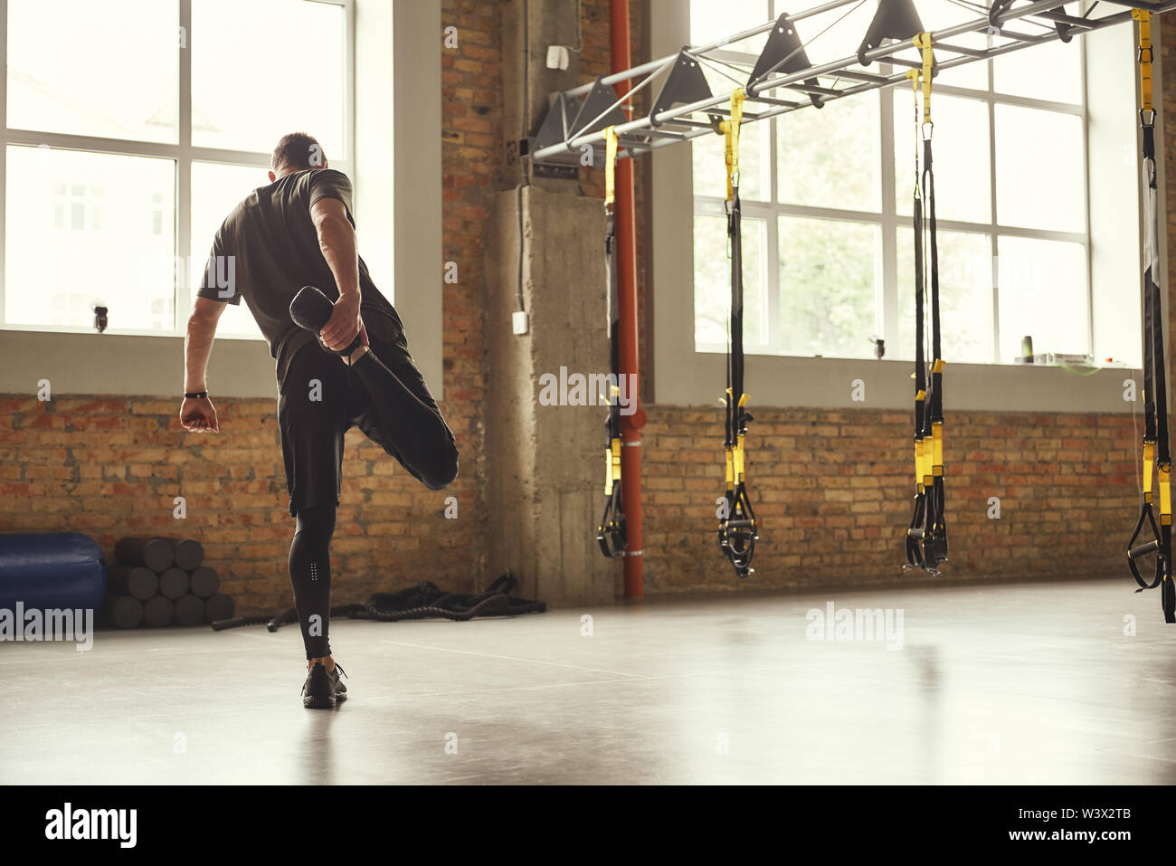 Great warm-up. Young sporty man in sportswear doing stretching ...