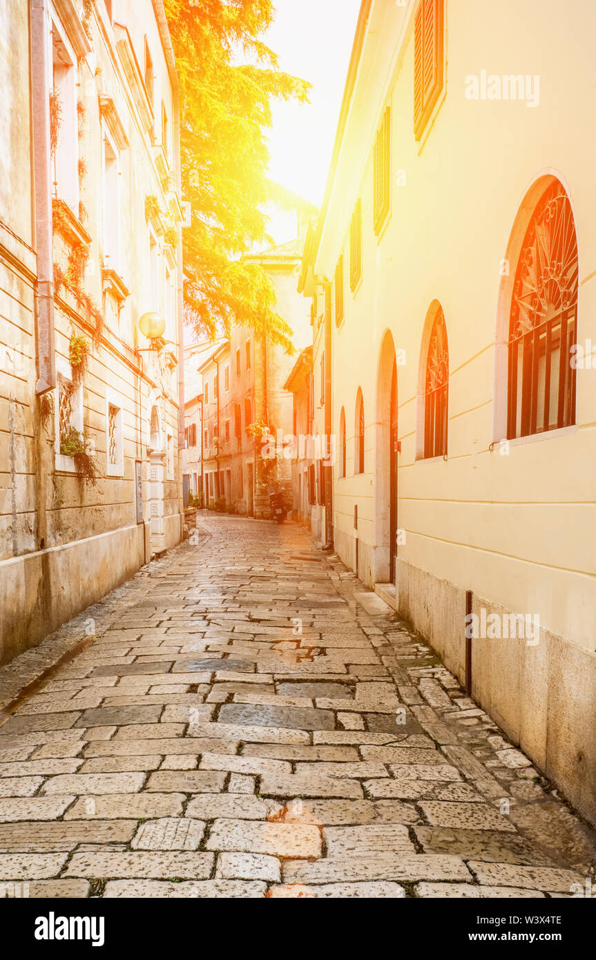A typical narrow European street with paved pavement on a Sunny day ...