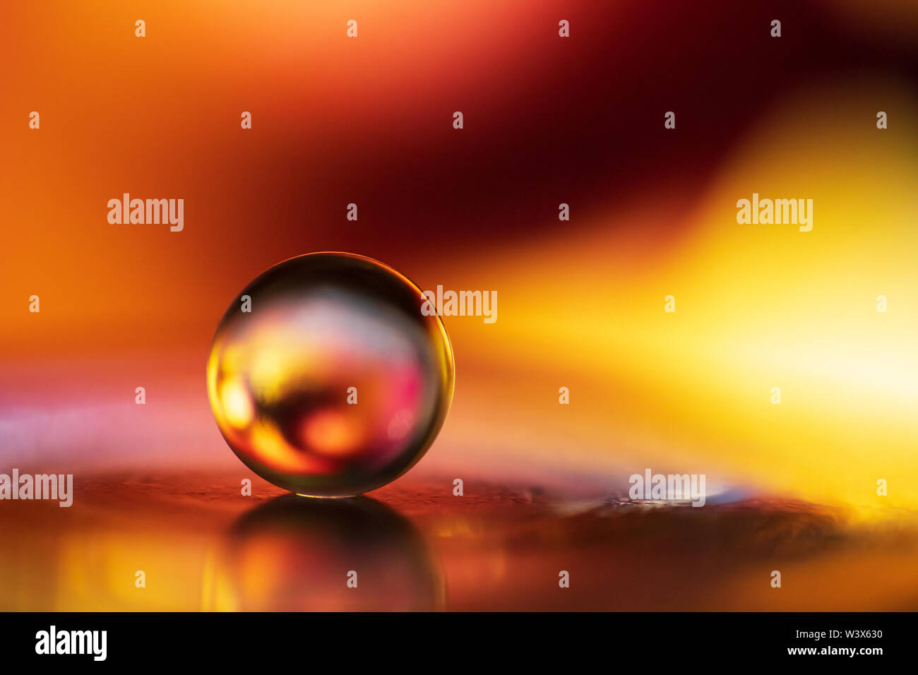 Small glass ball in abstract macro composition Stock Photo - Alamy