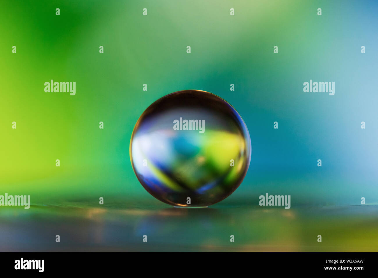 Small glass ball in abstract macro composition Stock Photo - Alamy