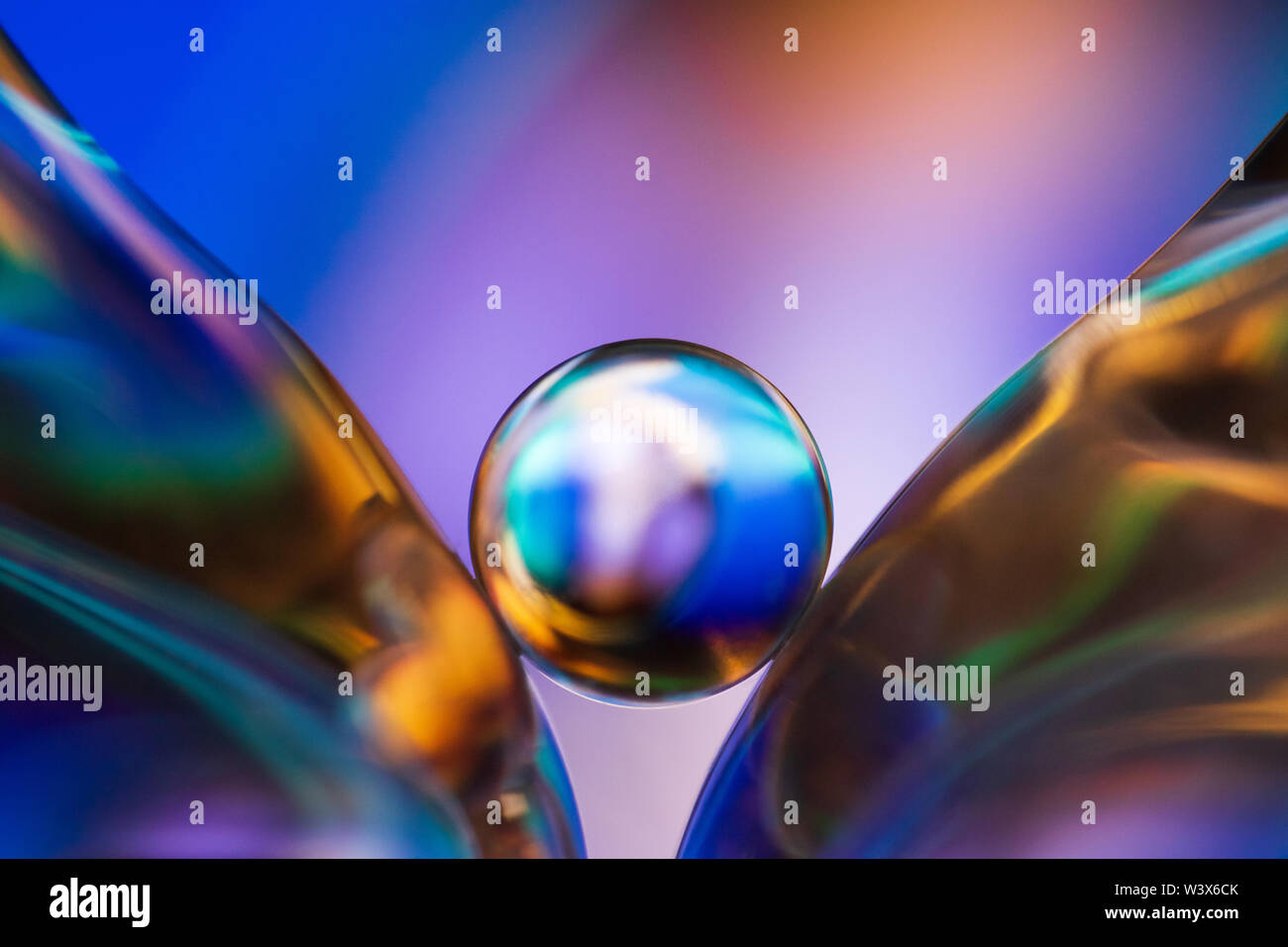 Small glass ball in abstract macro composition Stock Photo - Alamy