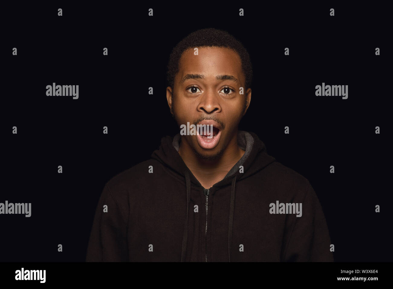 Close up portrait of young african-american man isolated on black ...