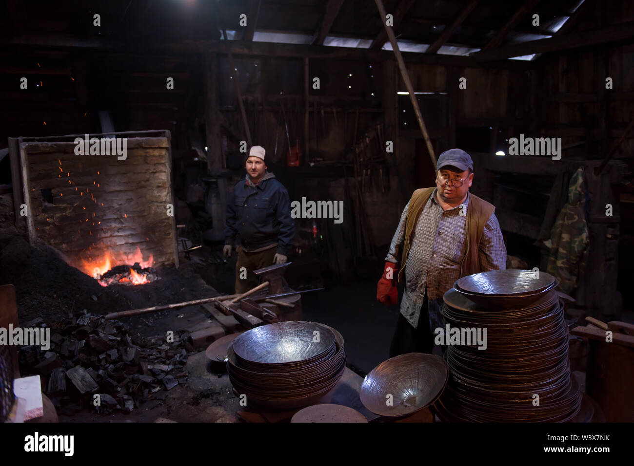 portrait of two generations traditional confident blacksmith workers at ...