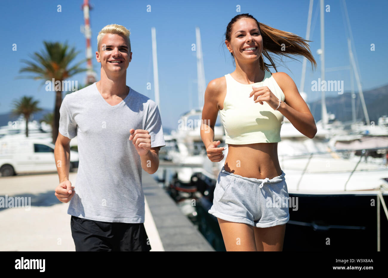 Running happy people hi-res stock photography and images - Alamy