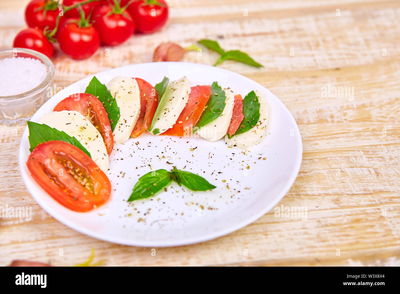 Italian caprese salad with sliced tomatoes, mozzarella cheese, basil ...