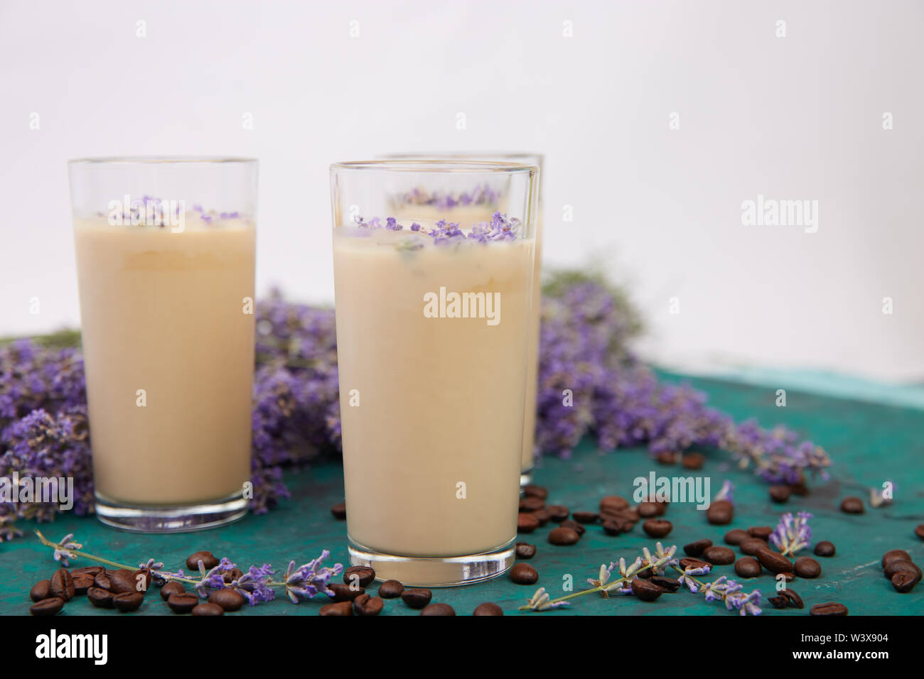 Summer drink iced coffee with lavender in glass and coffee beans on ...