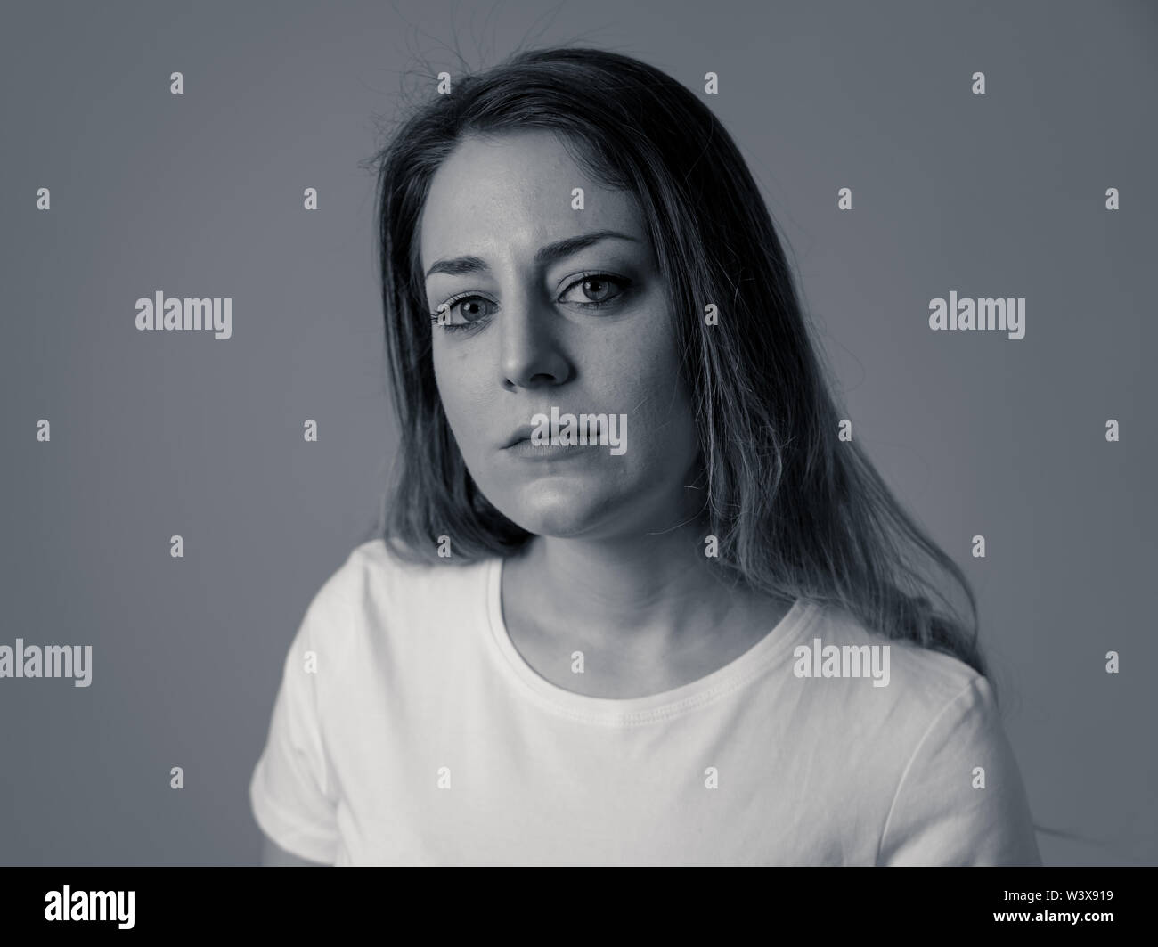 Close up portrait of beautiful young woman with sad mood looking ...