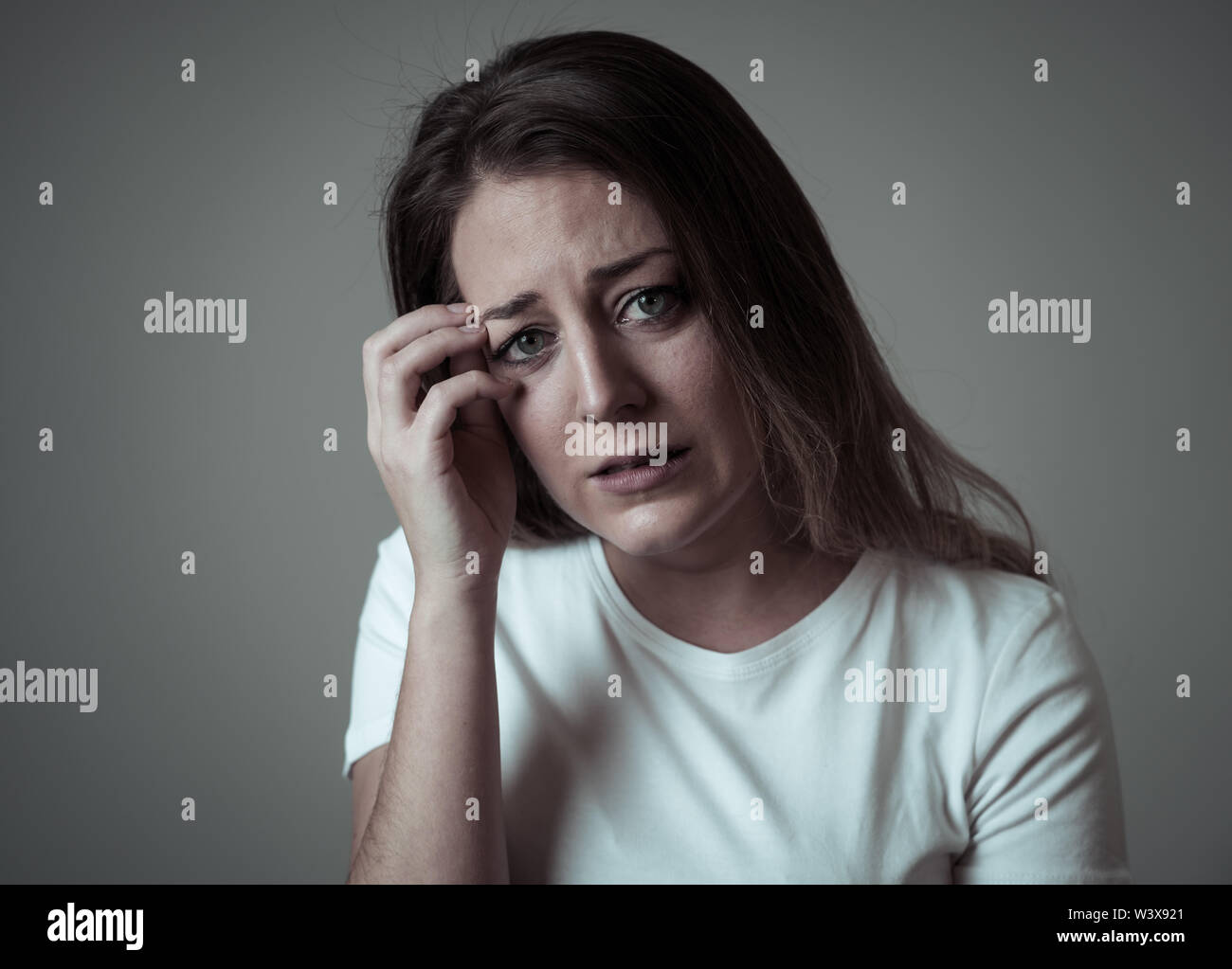 Close up portrait of beautiful young woman with sad mood looking ...