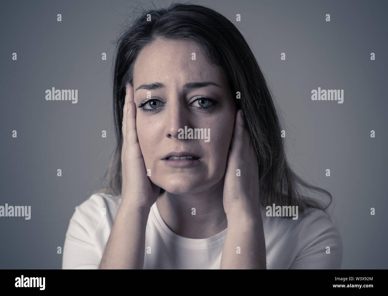 Close up portrait of beautiful young woman with sad mood looking ...