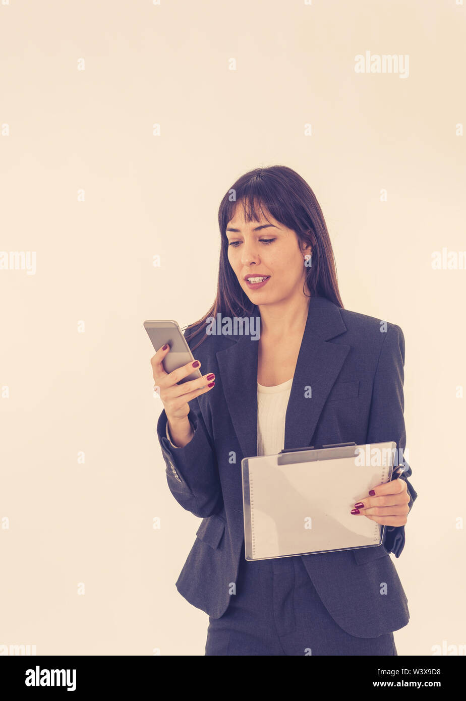 Close up of a young beautiful business woman standing speaking on the ...