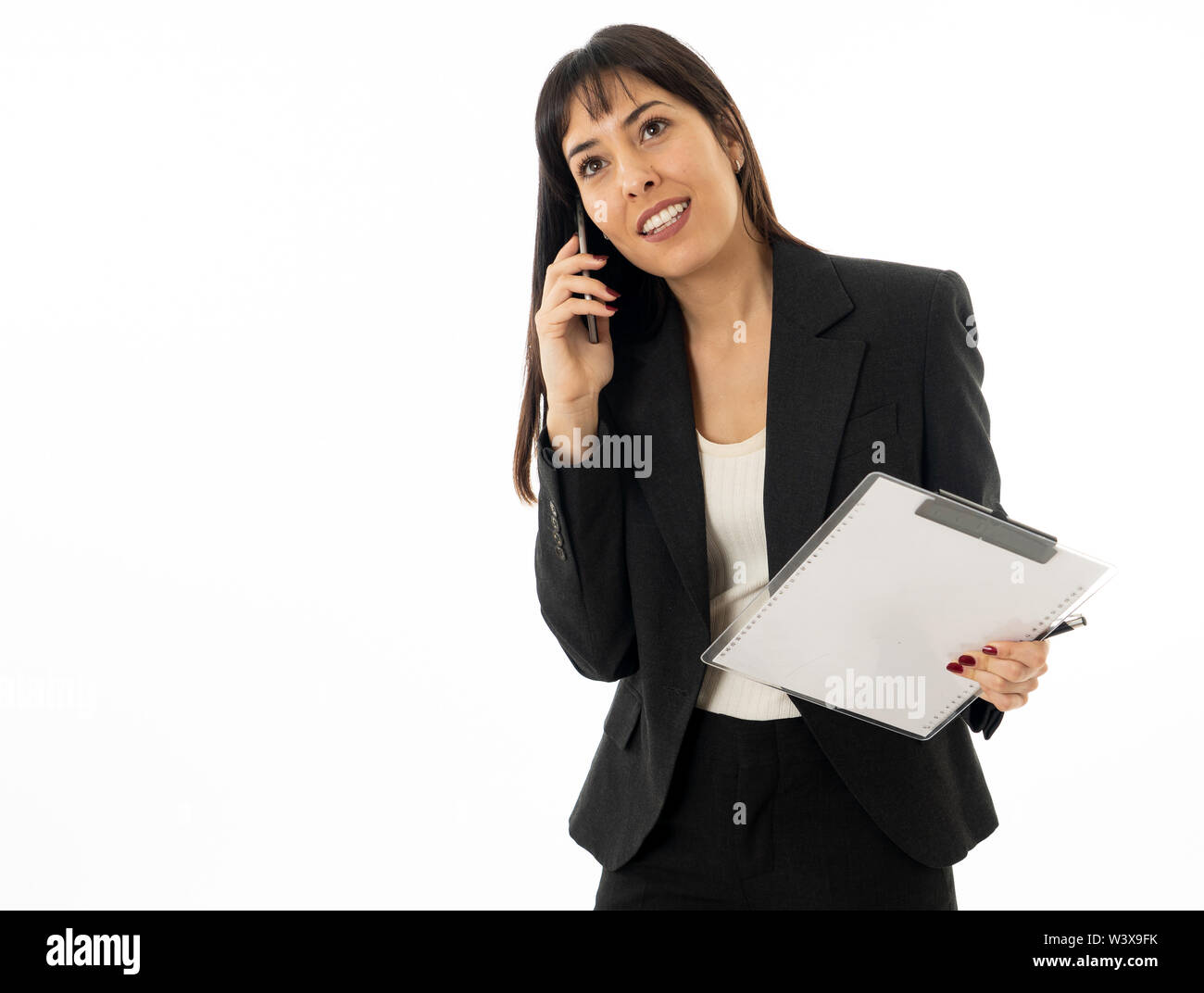 Close up of a young beautiful business woman standing speaking on the ...