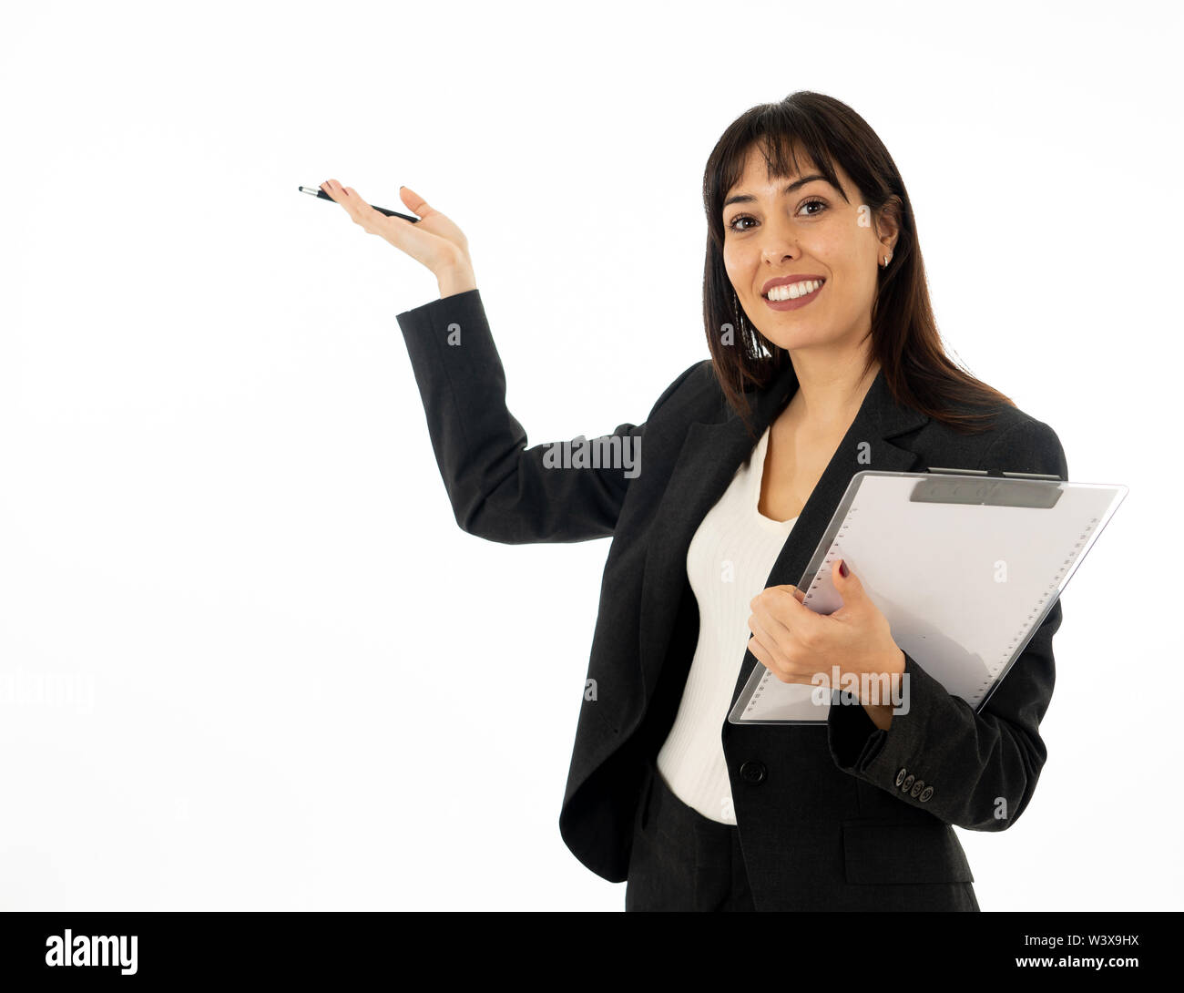 Close up of young pretty business woman standing pointing and holding a ...