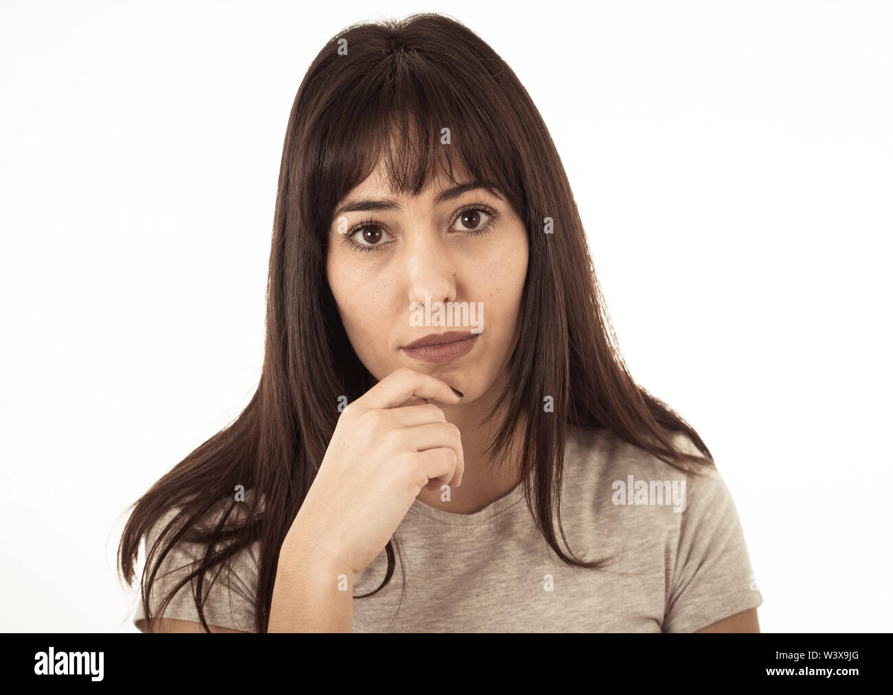 Close up of a young sad woman, serious and concerned, looking worried ...