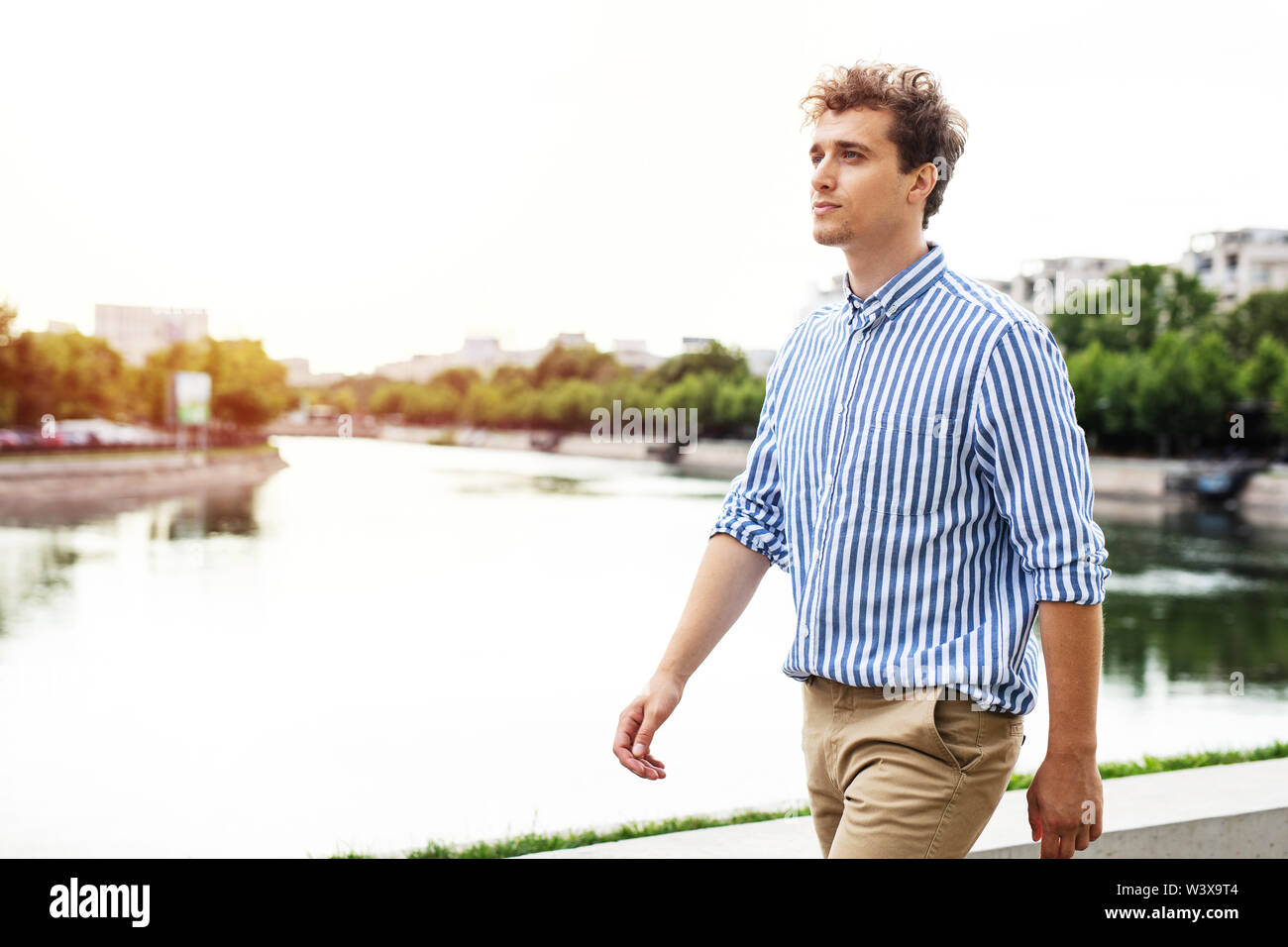 Young man walking by river hi-res stock photography and images - Alamy
