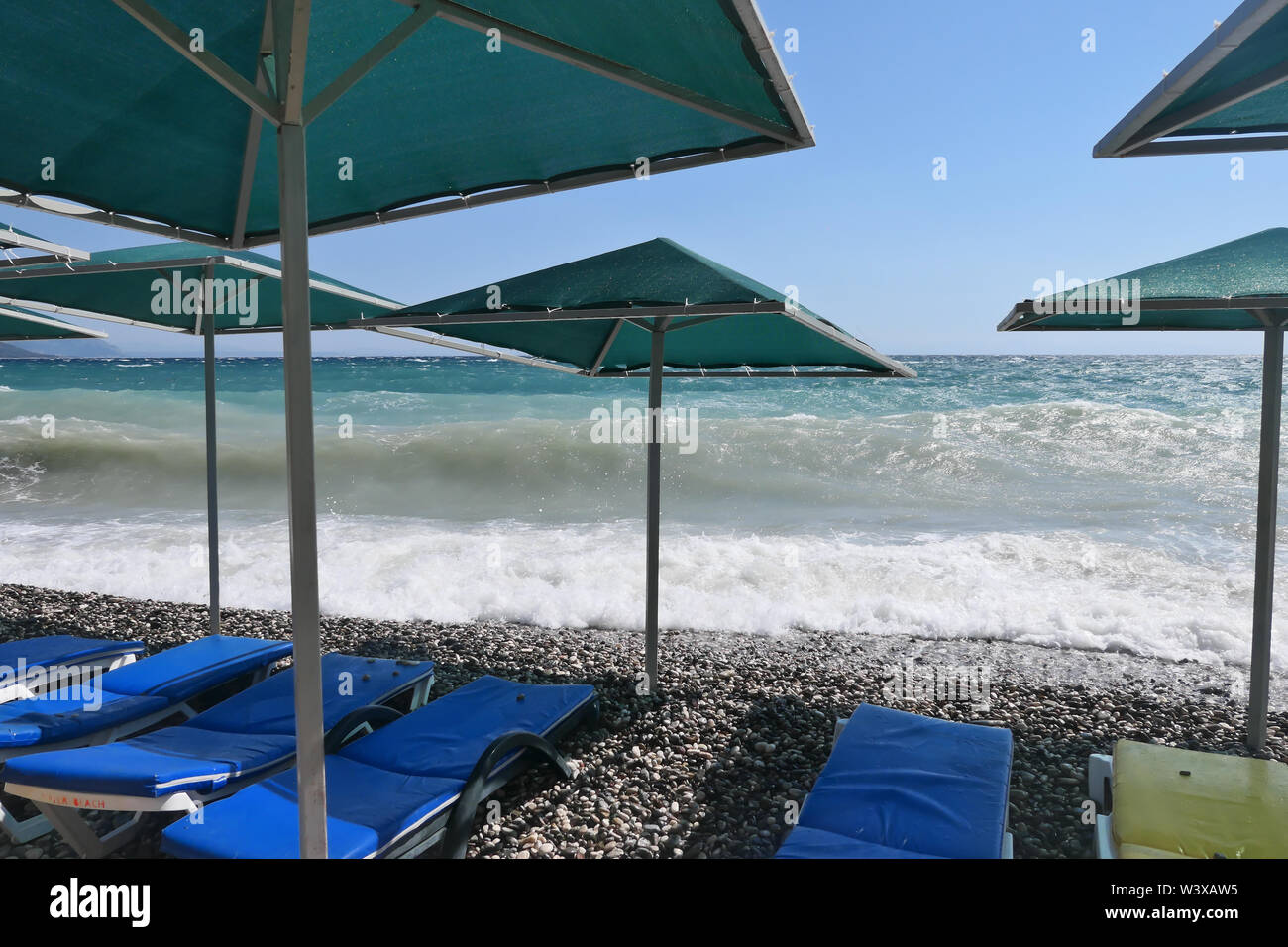 Windy weather on a beach, empty sunbeds Stock Photo - Alamy