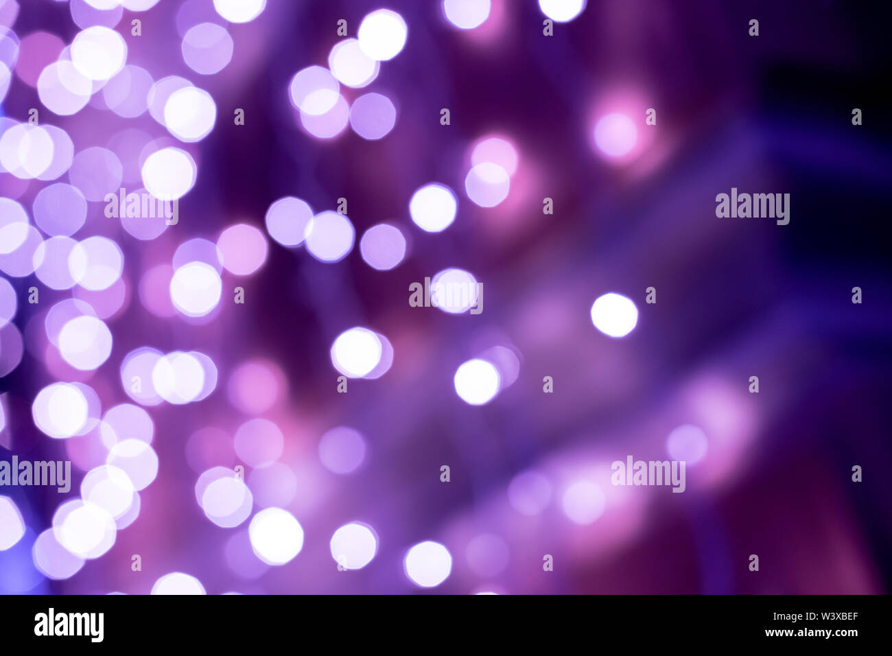 Purple bokeh blurred lights background. Violet garlands decoration for ...