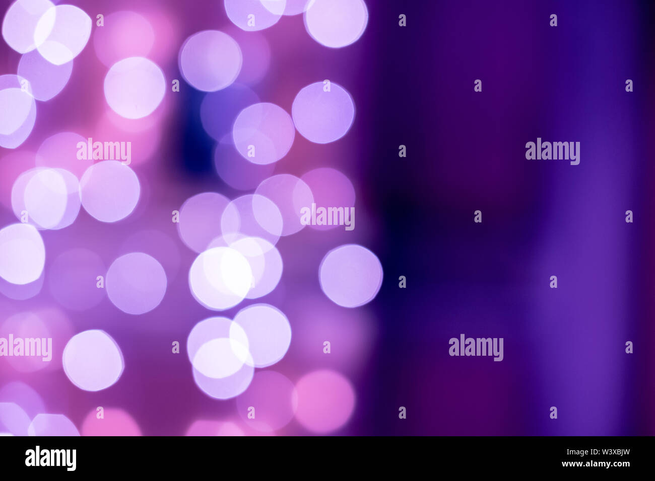 Purple bokeh blurred lights background. Violet garlands decoration for ...