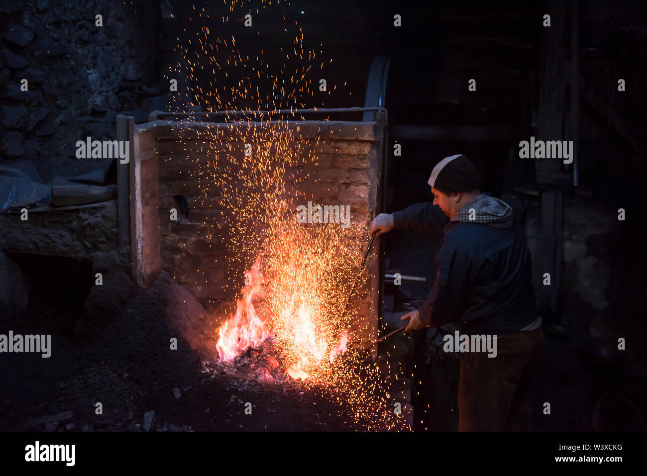 young traditional Blacksmith working with open fire The blacksmith ...