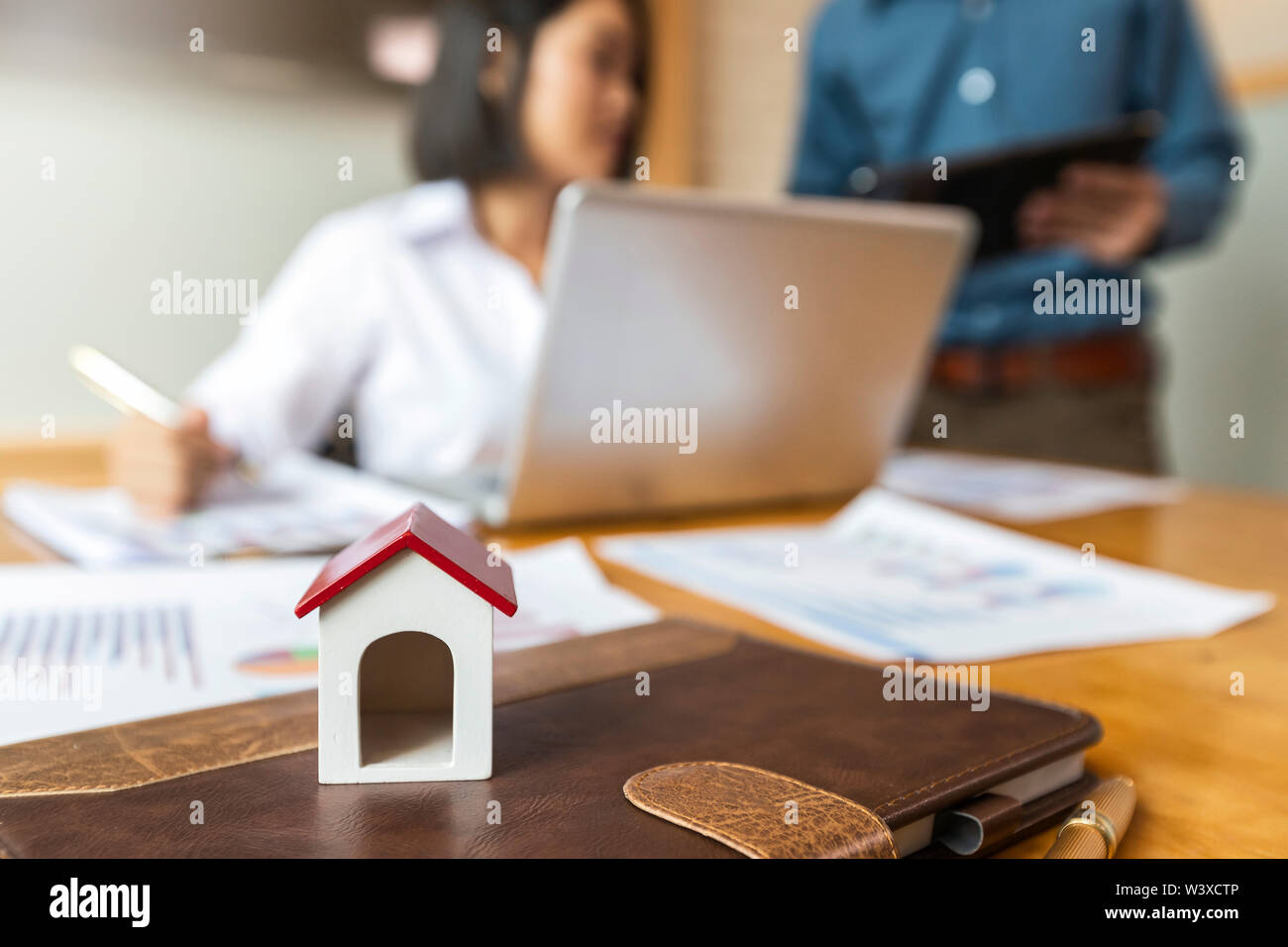 Business people are discussing about the real estate project behind ...