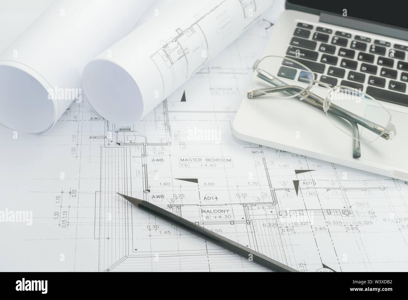 black pencil and computer laptop on architectural drawing paper for ...