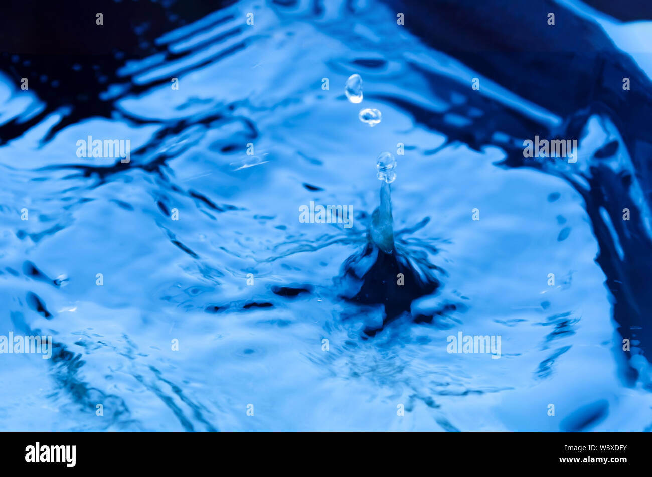 drop of water splash in blue color Stock Photo - Alamy