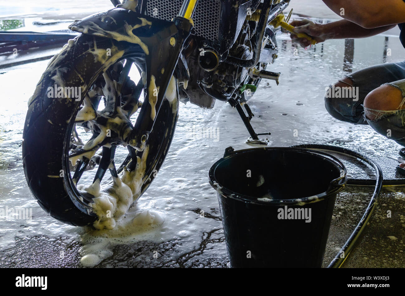 Wash motorcycle with foam Stock Photo - Alamy