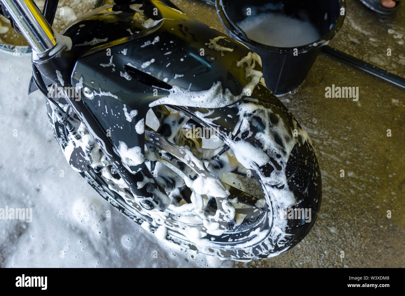 Wash motorcycle with foam Stock Photo - Alamy