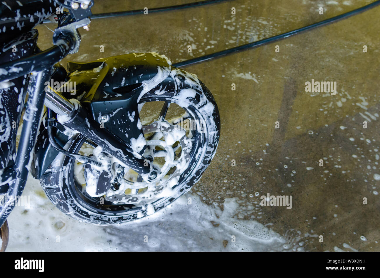 Wash motorcycle with foam Stock Photo - Alamy
