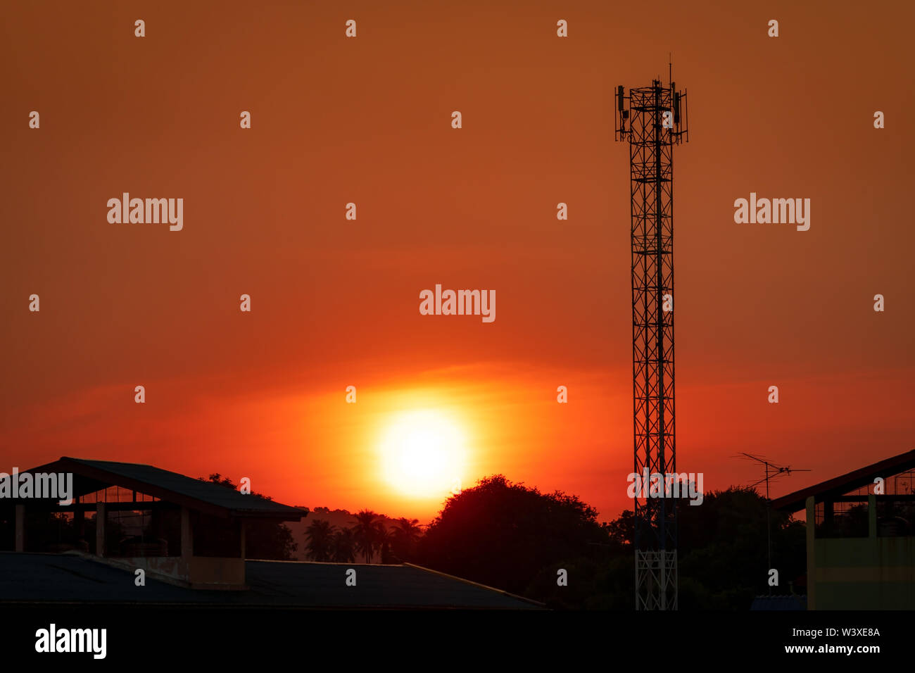 Beautiful red and orange sunset sky. Silhouette telecommunication tower ...