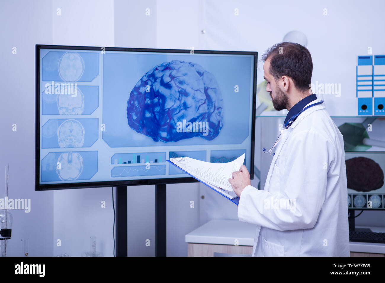 Doctor checking the brain analyzes of a patient on his clipboard ...