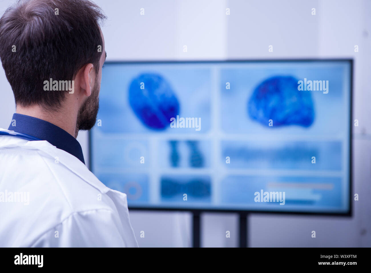 Young male doctor checking his patient brain after surgery. Doctor in ...