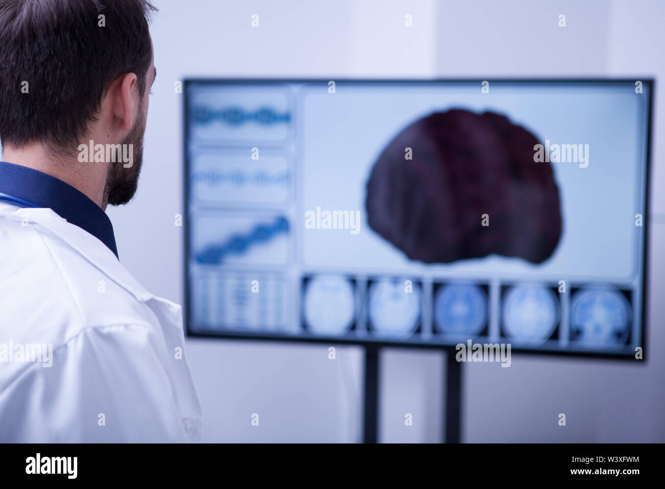 Young male surgeon using technology to check out a patient brain. Brain ...